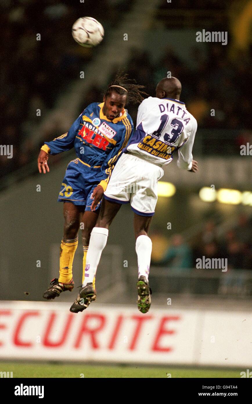 Toulouse's Lamine Diatta (right) heads clear from Strasbourg's Guy ...