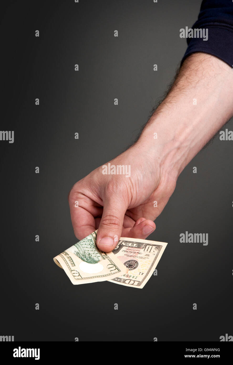 A Male Hand with Dollars Paying Money on Black Stock Photo - Alamy
