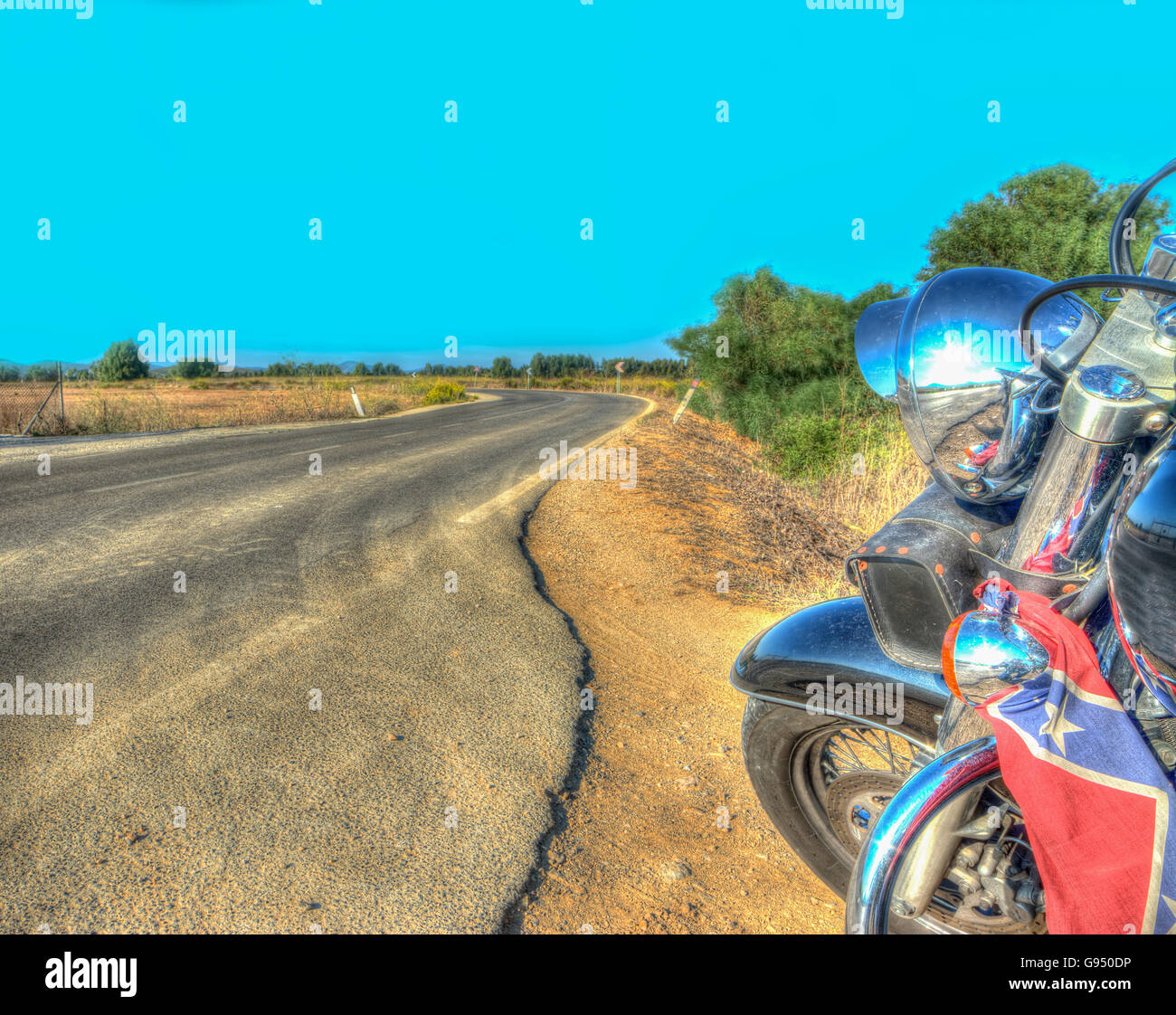 classic motorcycle on the edge of a winding road. heavy processed for ...