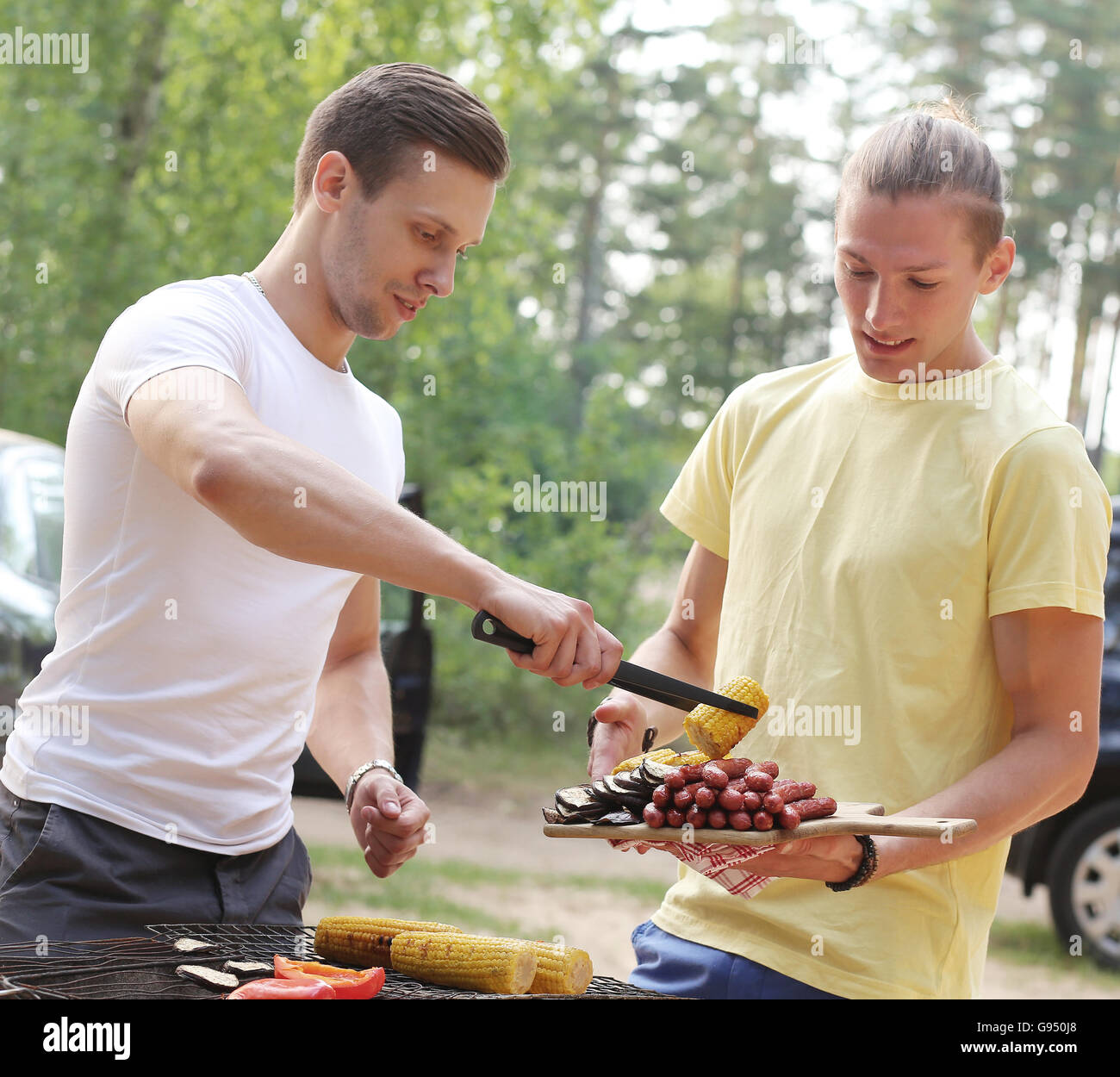 Group of people enjoying picnic meal together hi-res stock photography ...