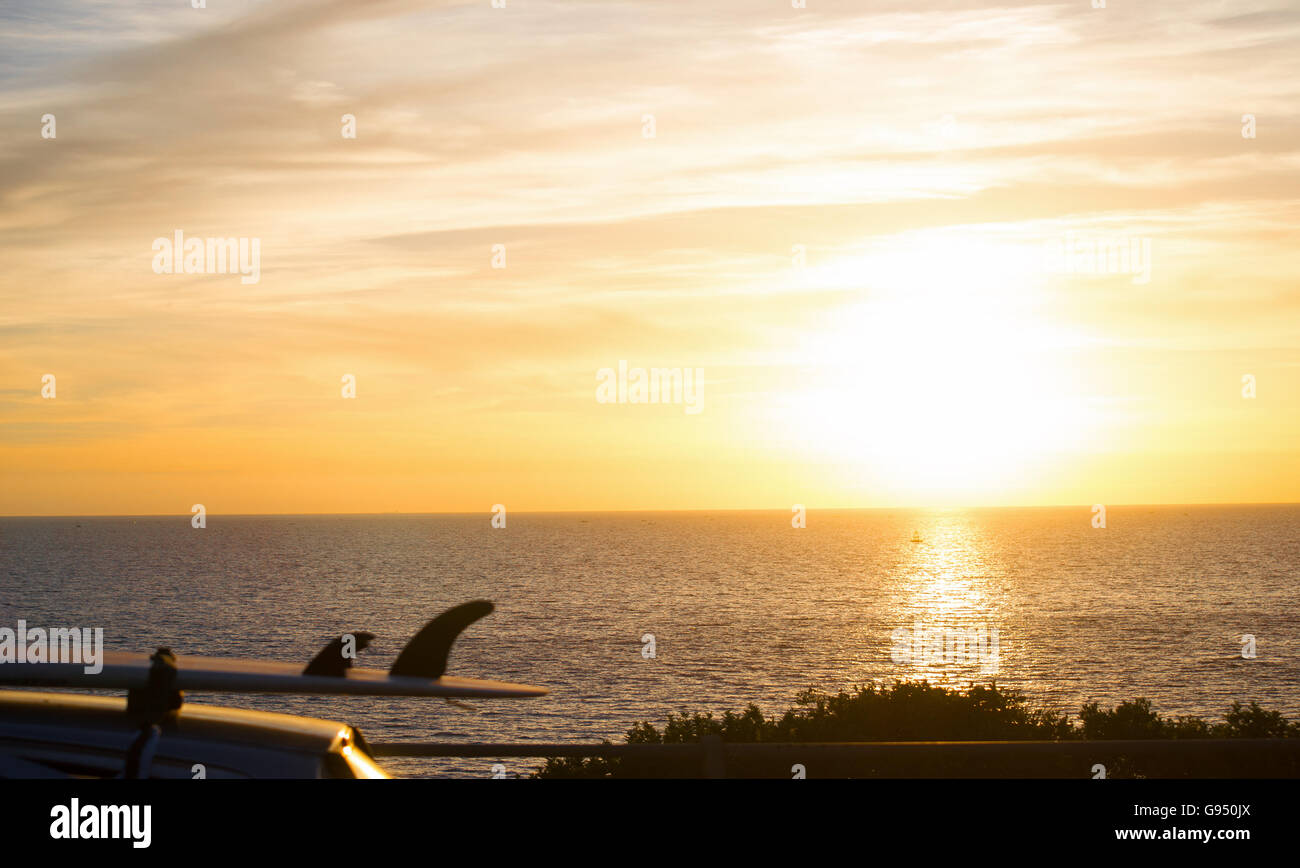 surfboard on a car rooftop by the sea at sunset Stock Photo - Alamy