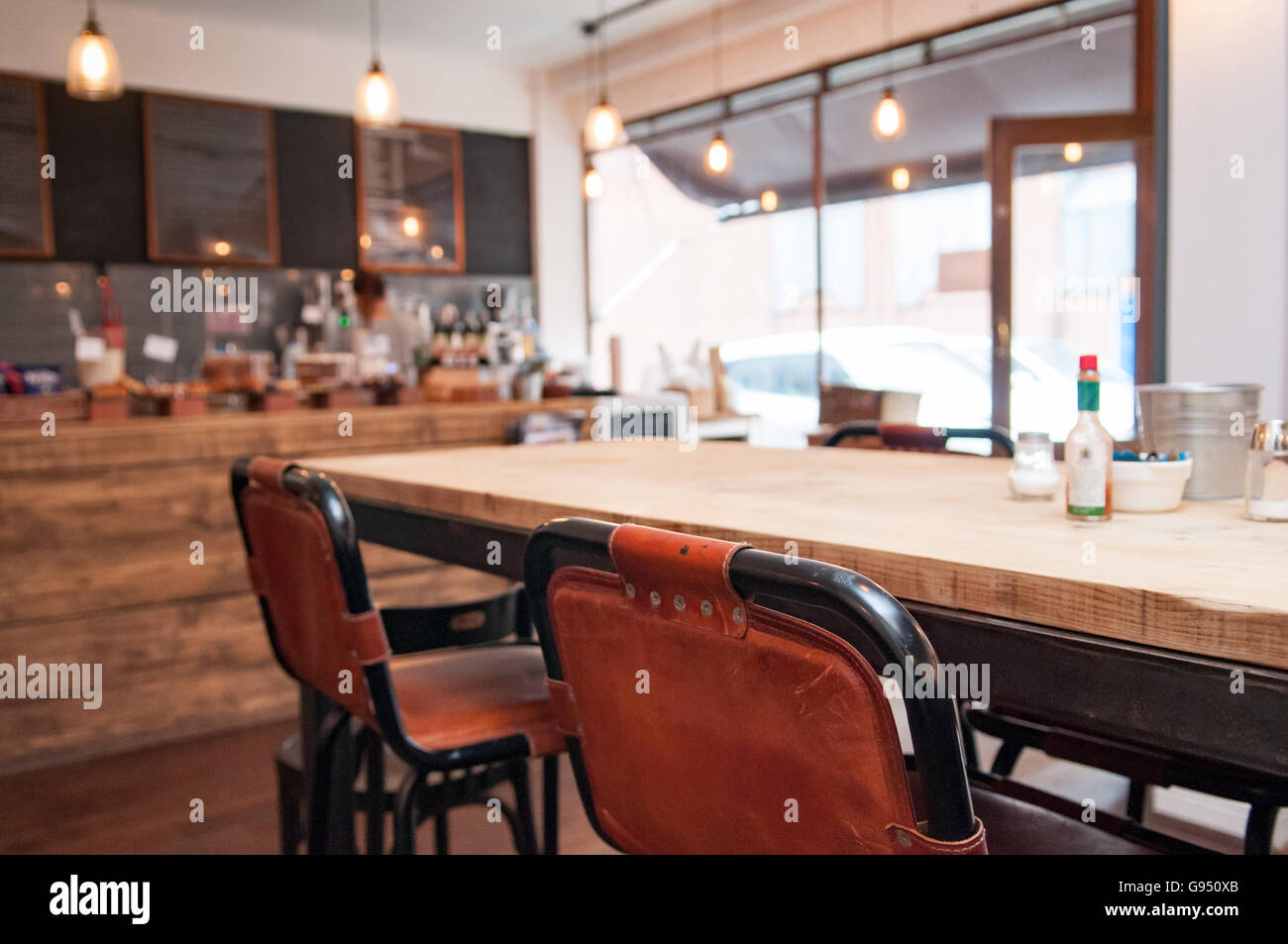 Interior of a rustic coffee shop with a large wooden table in ...
