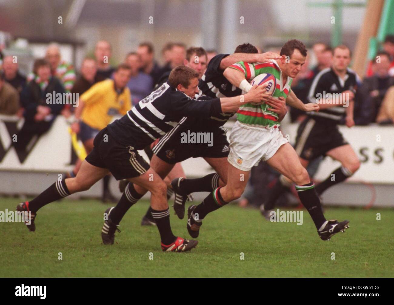 Leicester's Austin Healey (right) is caught by Newcastle's Jonny ...