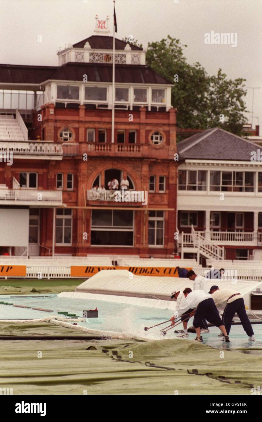 The players watch from the balcony as the Lord's groundstaff sweep the ...