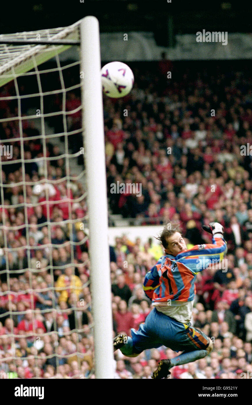 Tottenham Hotspur goalkeeper Ian Walker looks back in mid-air to see ...