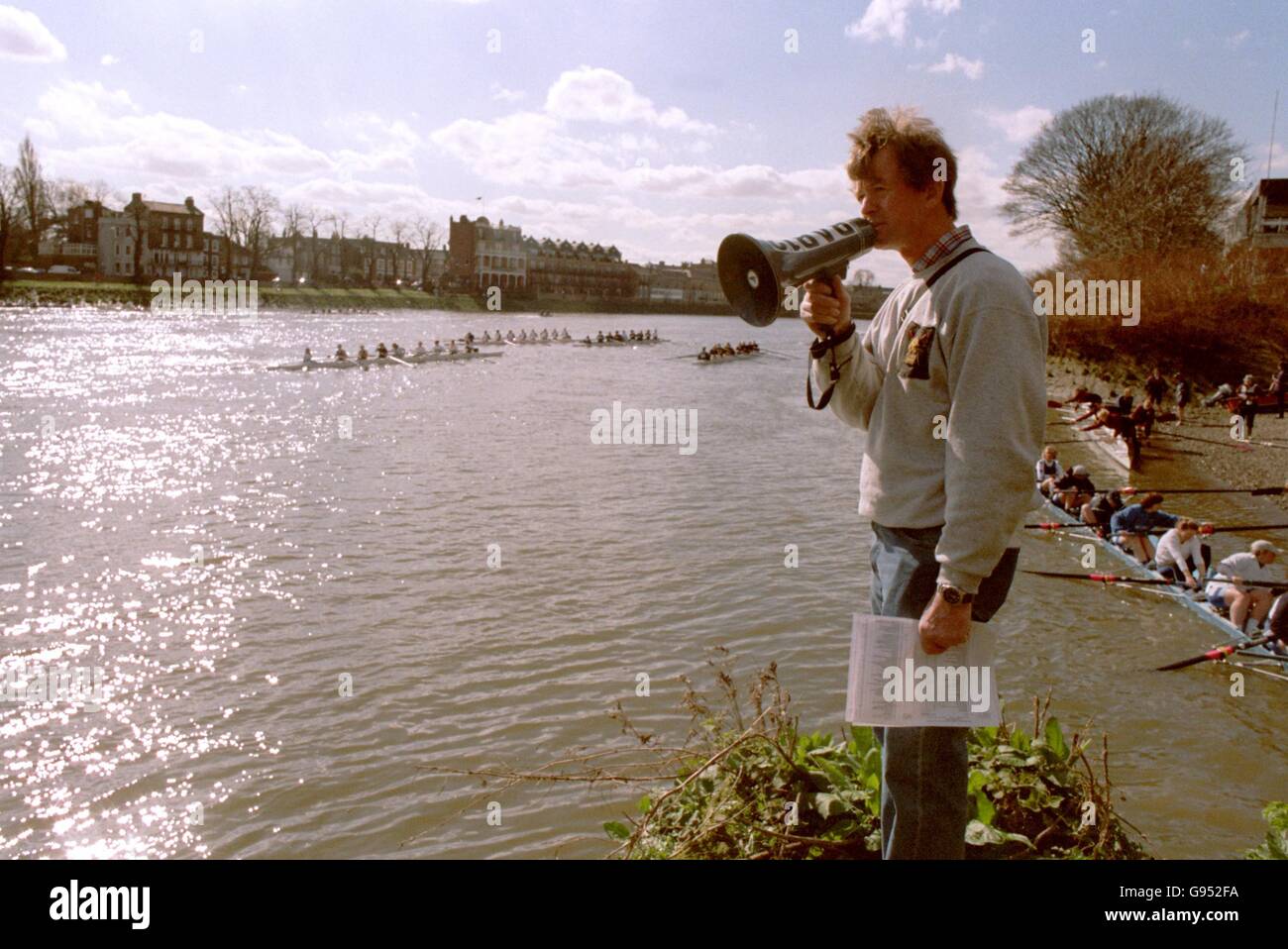A rowing coach shouts last minute instructions, organising crews ...