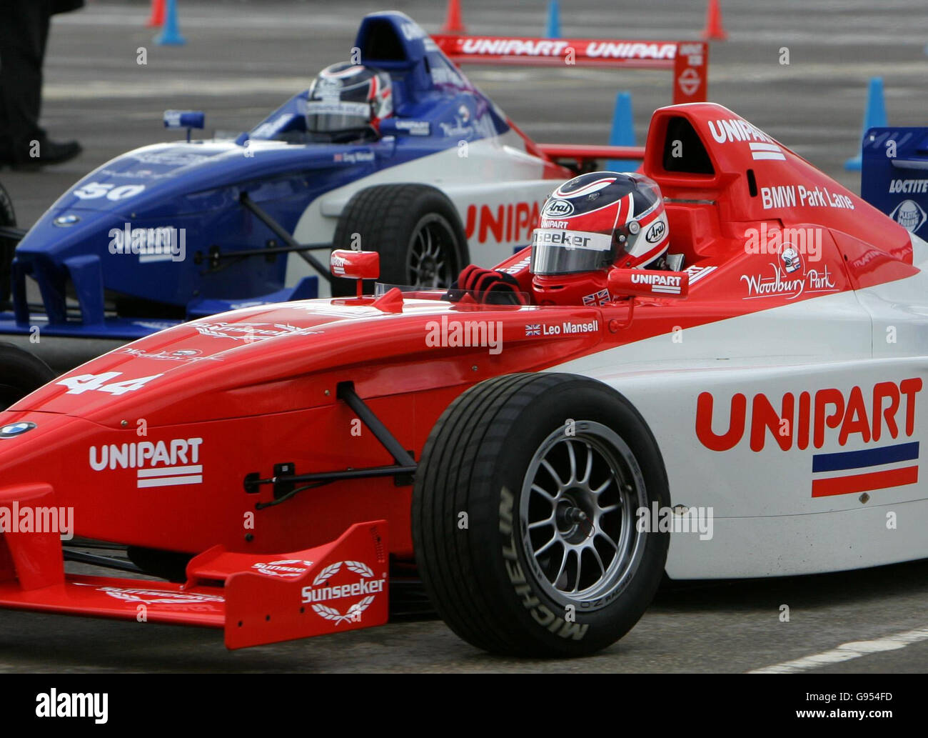 Leo Mansell (red) and his brother Greg (blue) drive their cars during a ...