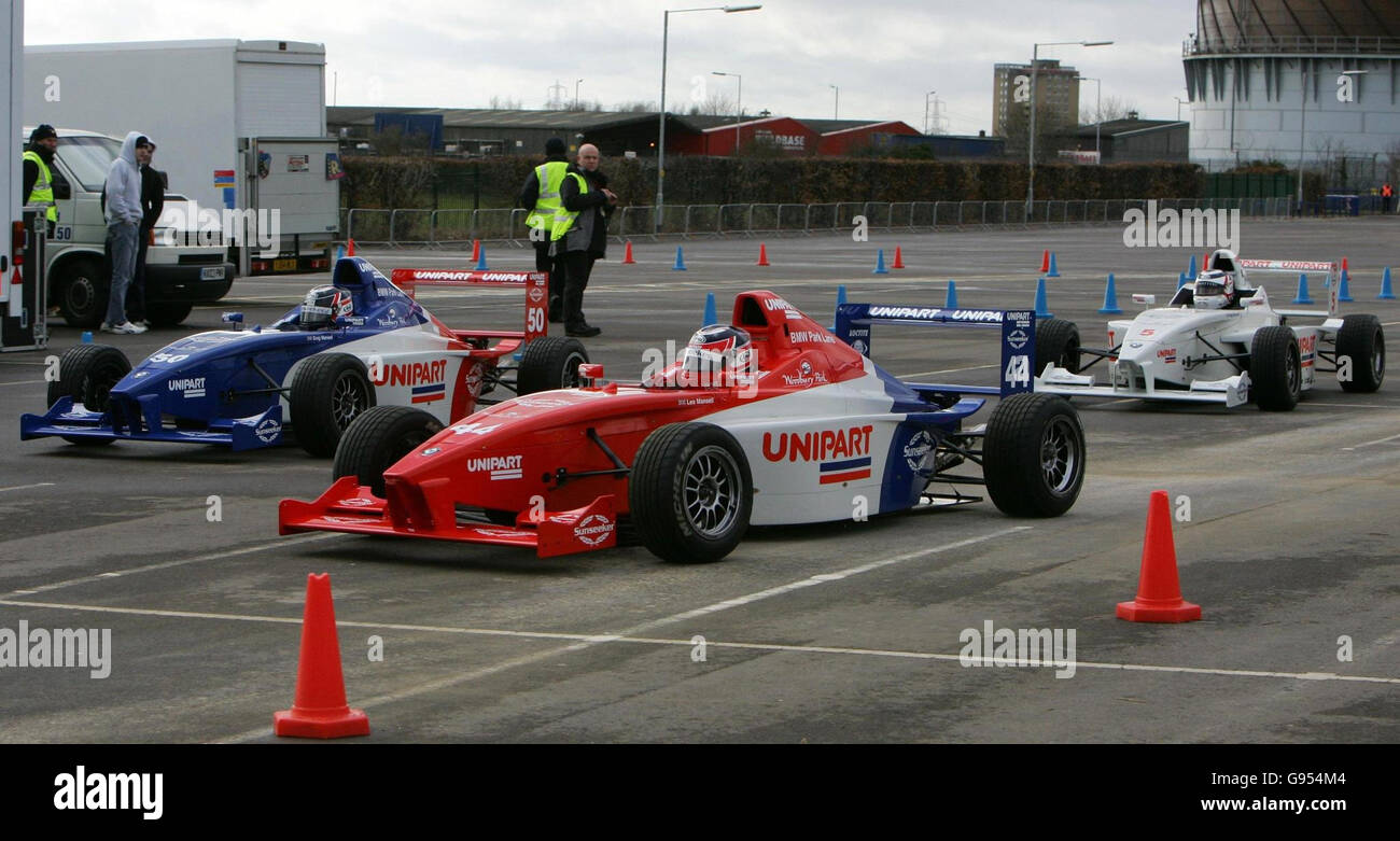Leo Mansell (red car) and Greg Mansell (blue car) lead their father ...
