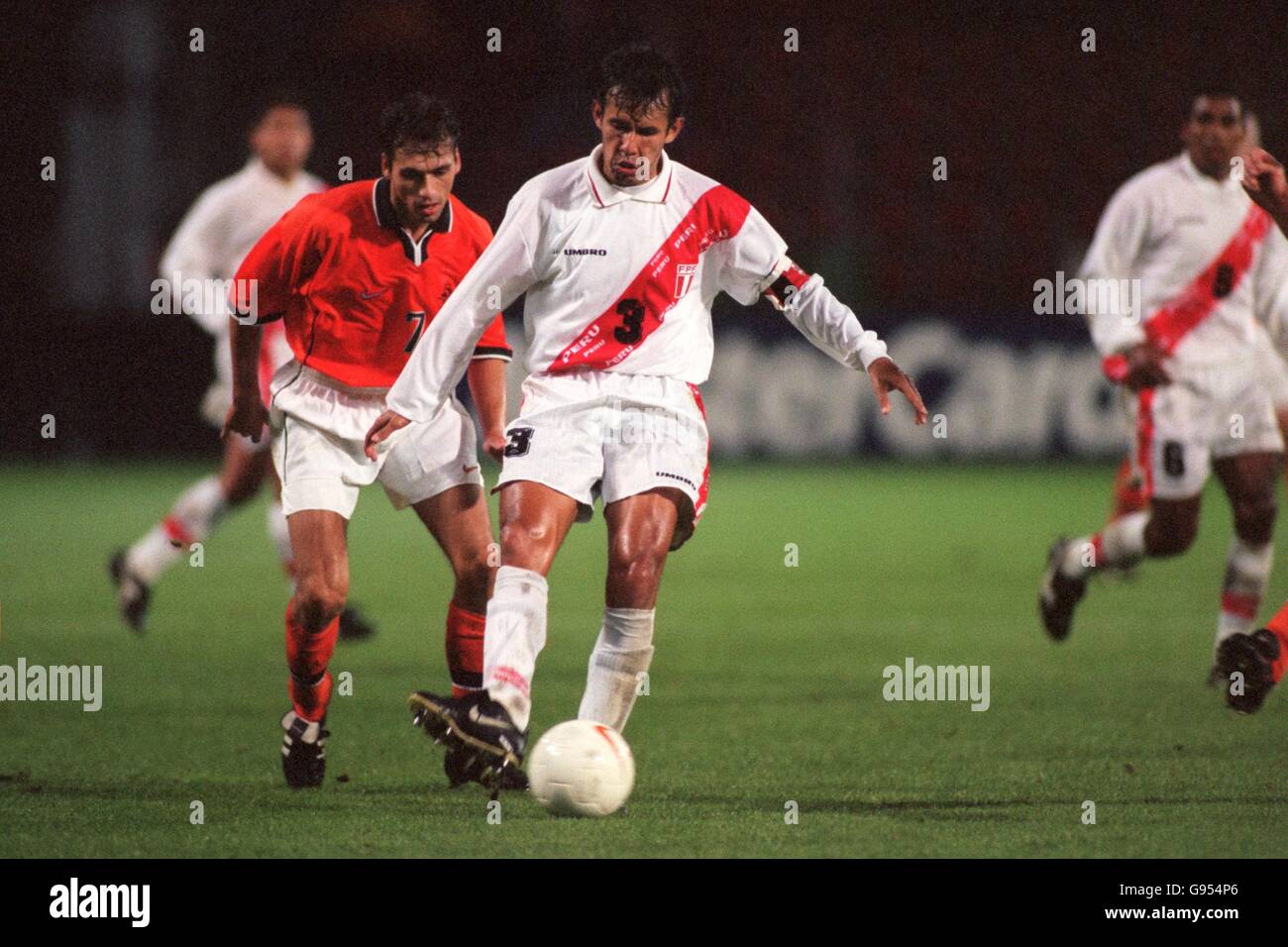 Soccer - Friendly - Holland v Peru. Peru's Juan Reynoso (right) shields ...