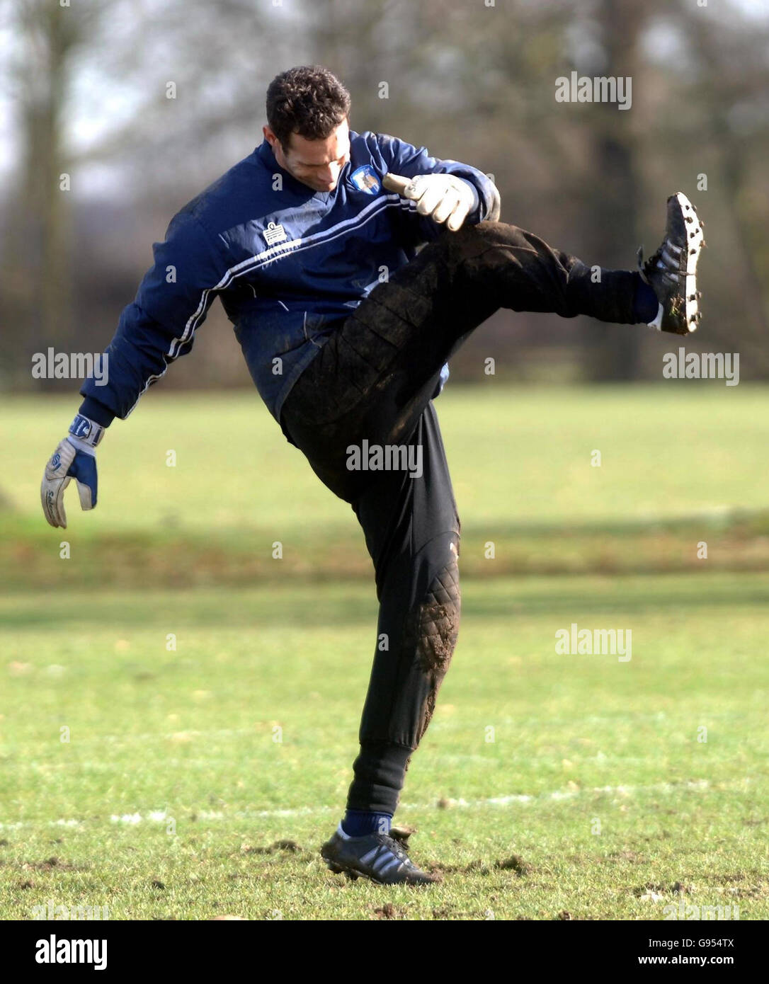 Colchester goalkeeper Aiden Davidson stretches during a training ...