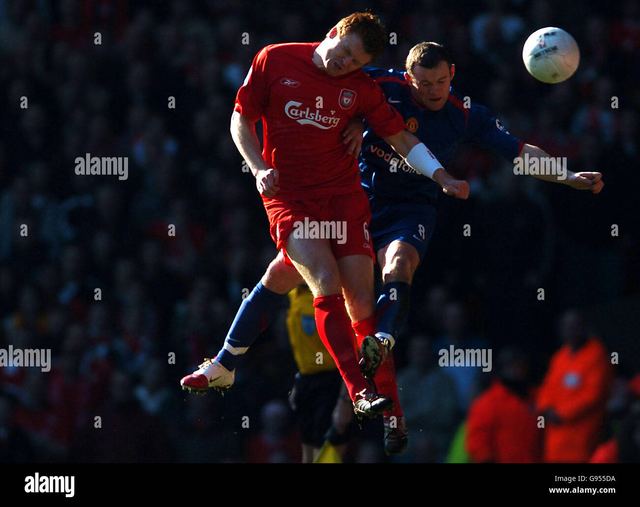 Liverpools john arne riise challenges manchester uniteds wayne rooney ...