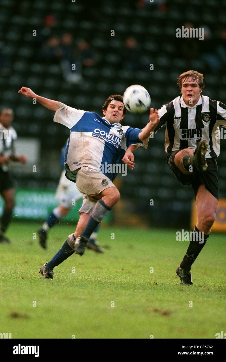 Robert Trees of Bristol Rovers (left) battles for the ball with Matthew ...