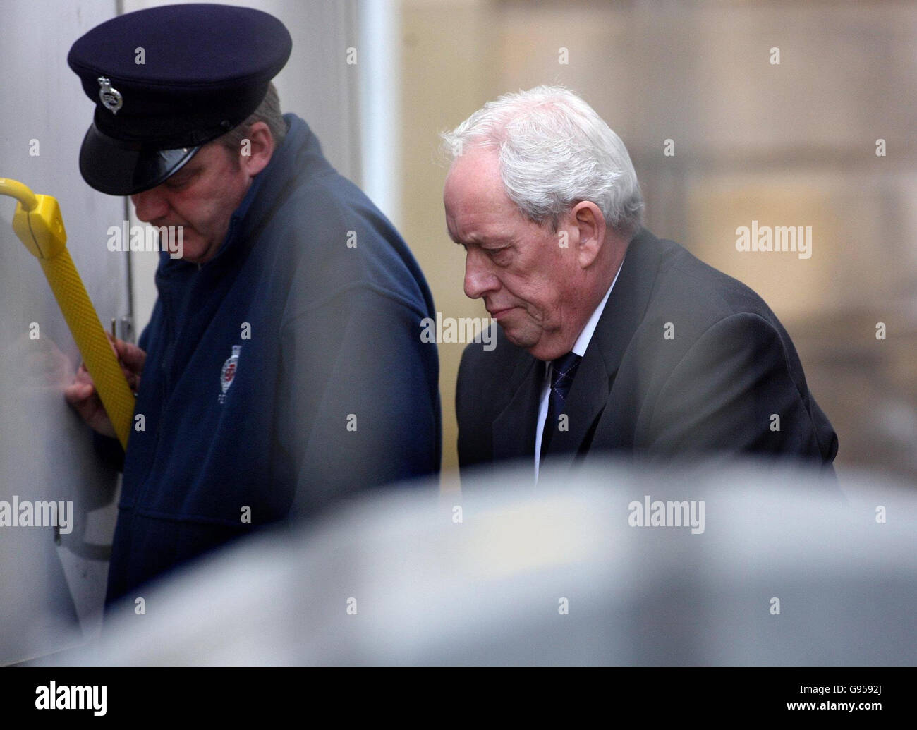 Former hypnotist Richard Tilley (right), 67, is led into a prison van ...