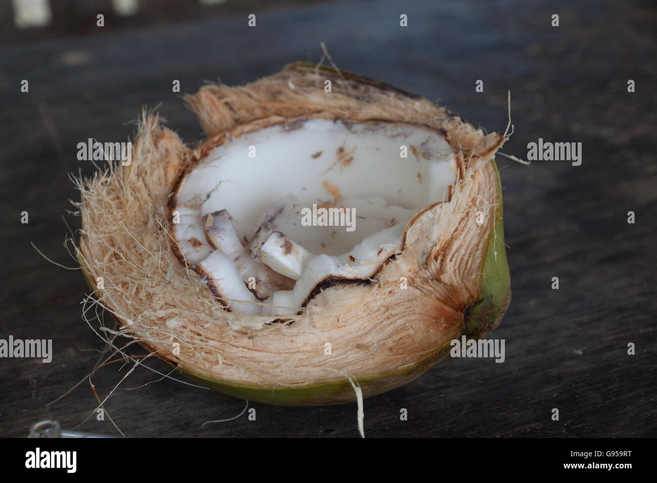 Fresh green young coconut split in half showing white flesh Stock Photo ...