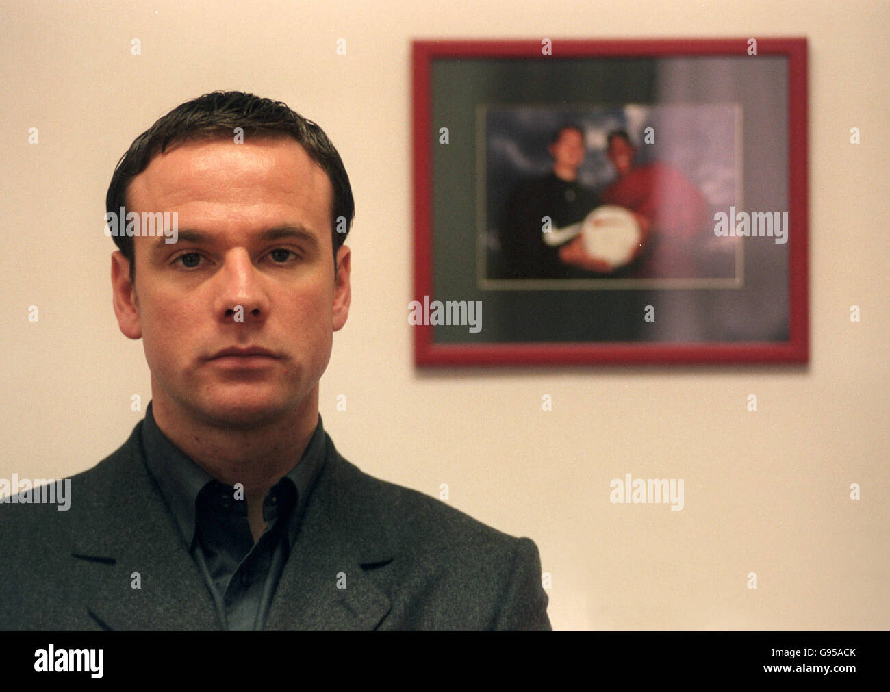 Struan Marshall, soccer agent, in front of a picture of himself with ...