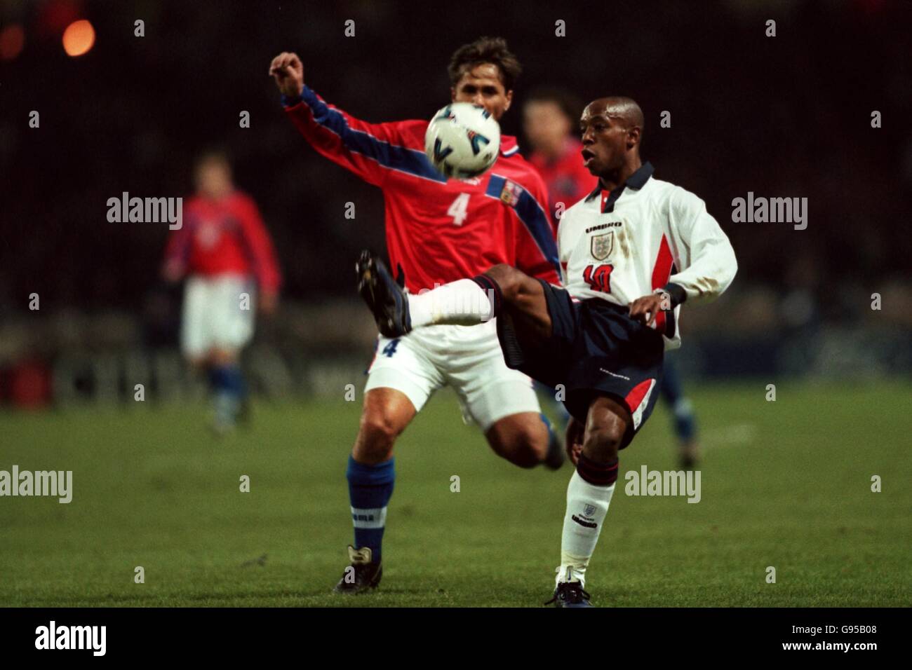 Ian Wright of England (right) shows skill to control the ball as Jiri ...
