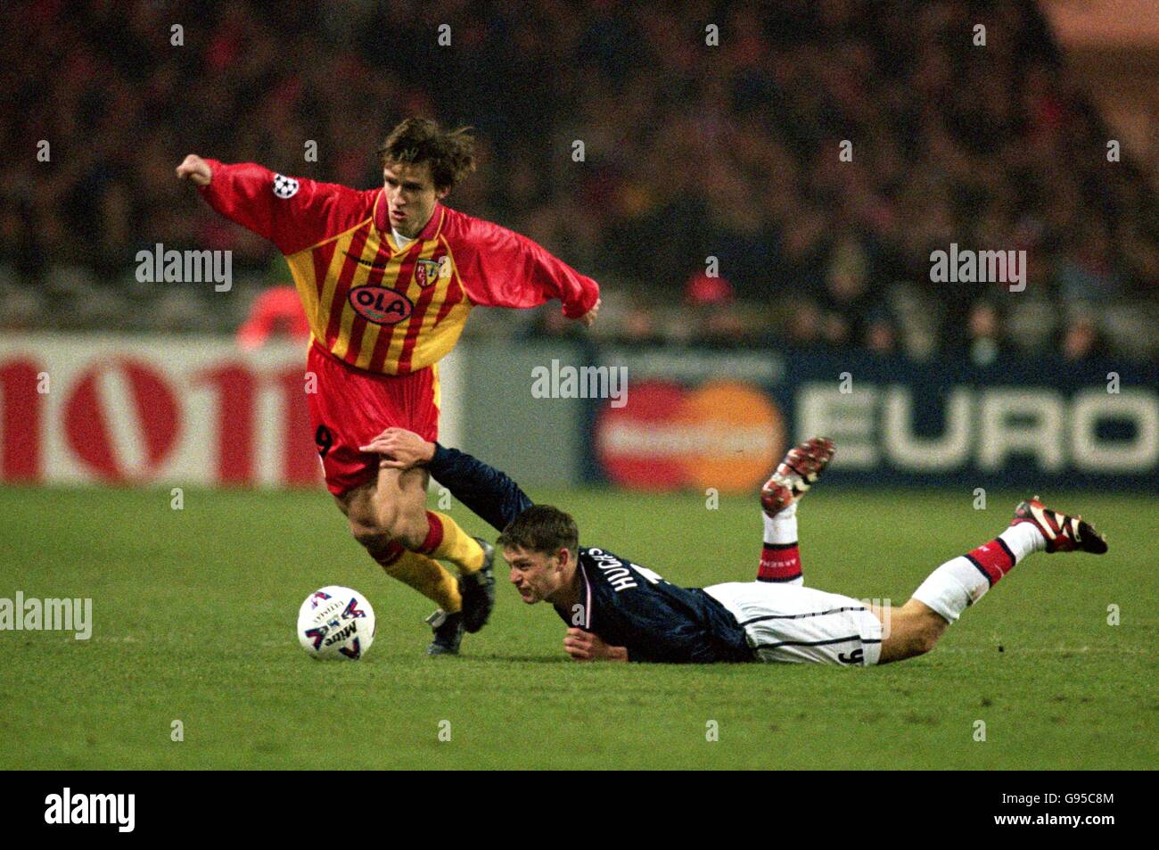 Arsenal's Stephen Hughes attempts to block RC Lens's Alex Nyarko Stock ...