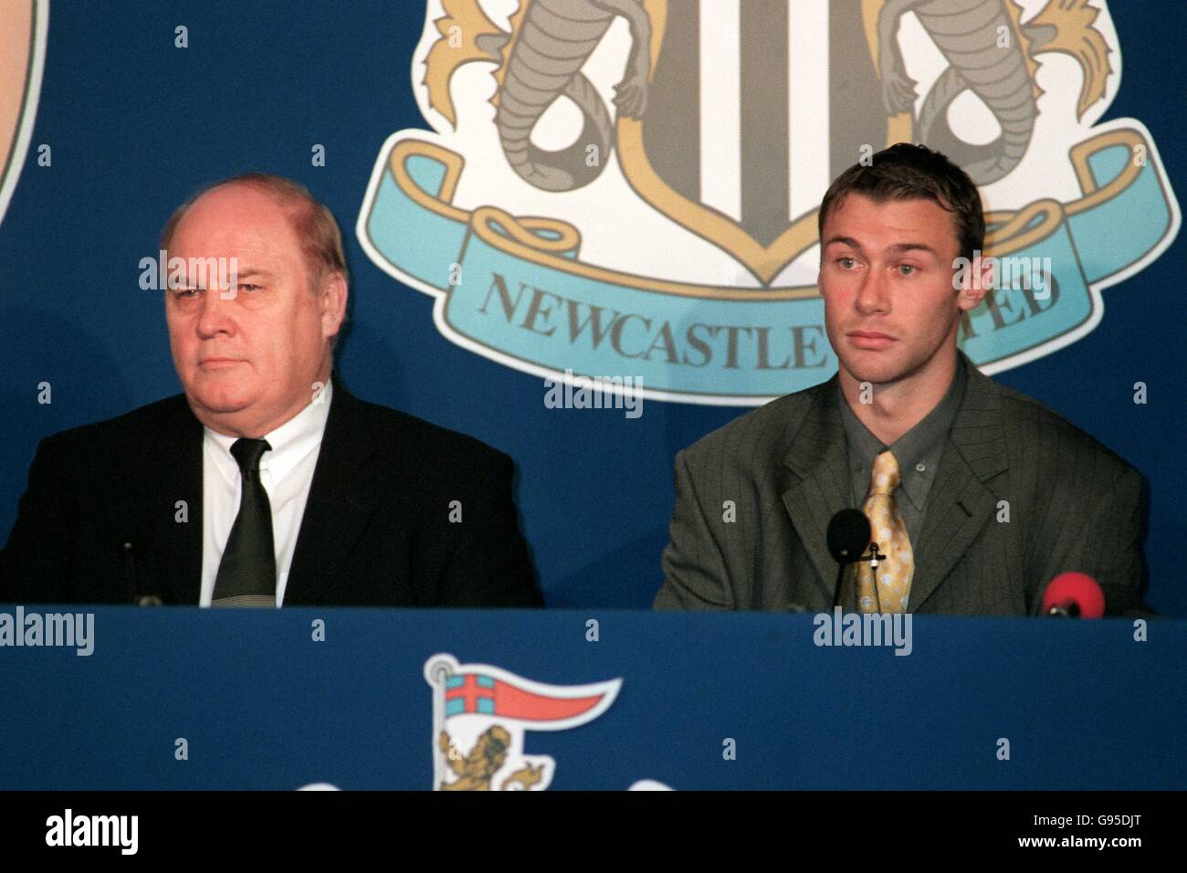 Duncan Ferguson (right) sits in front of the Newcastle United badge ...