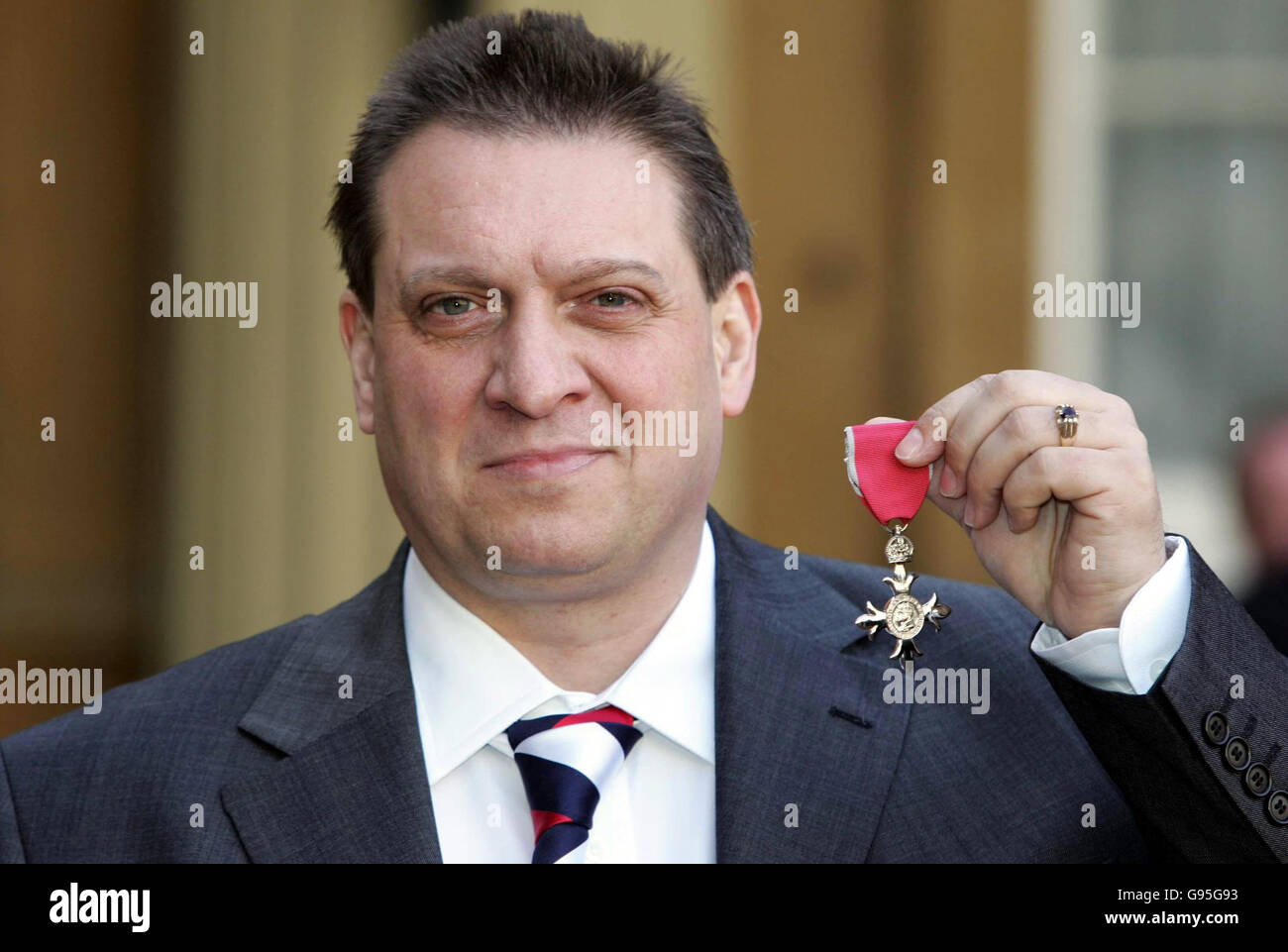 Alan Dell from London buses holds his MBE at Buckingham Palace ...