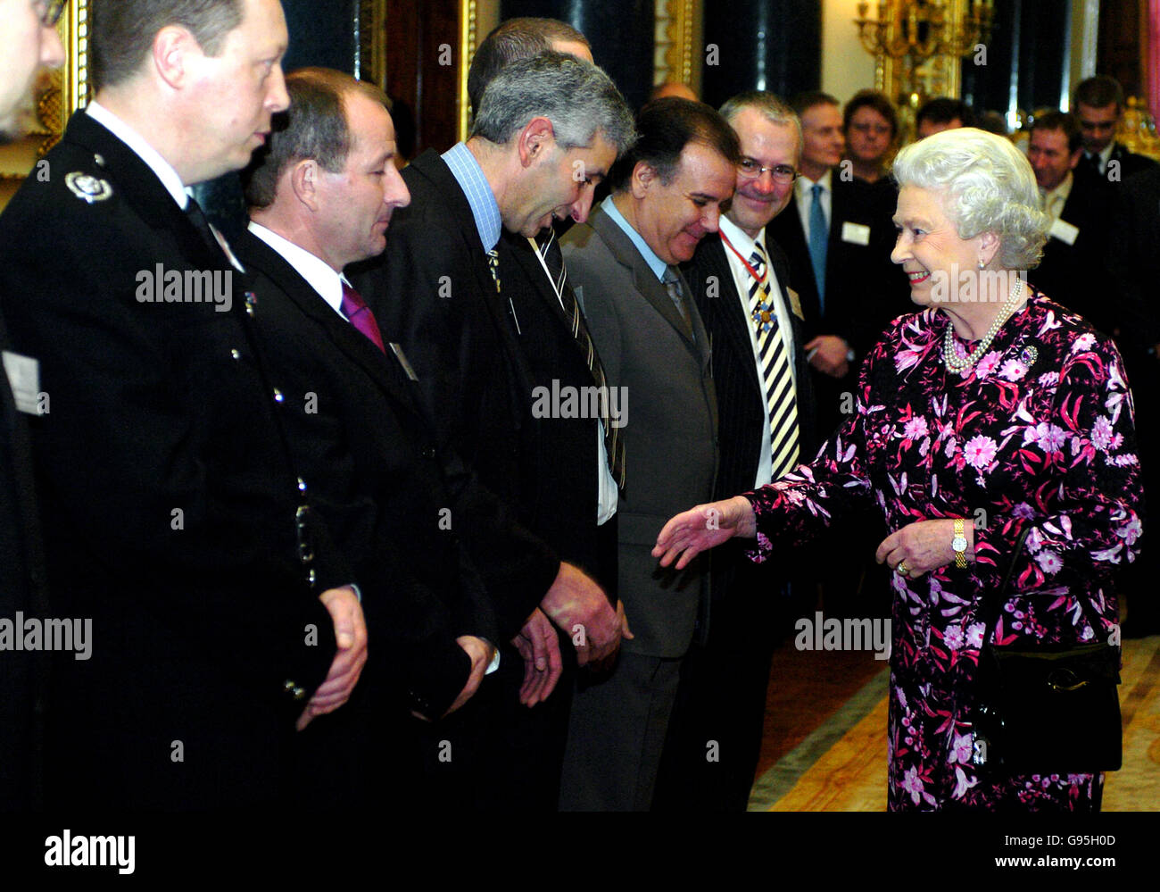 Britain's Queen Elizabeth II meets emergency service workers including ...