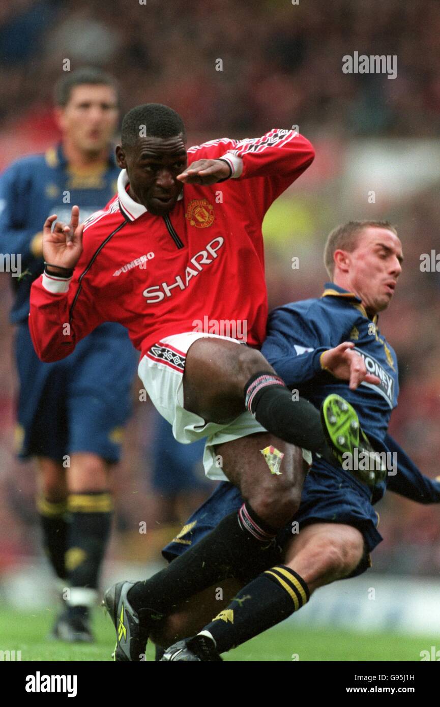 Manchester United's Andy Cole (left) beats Wimbledon's Chris Perry ...
