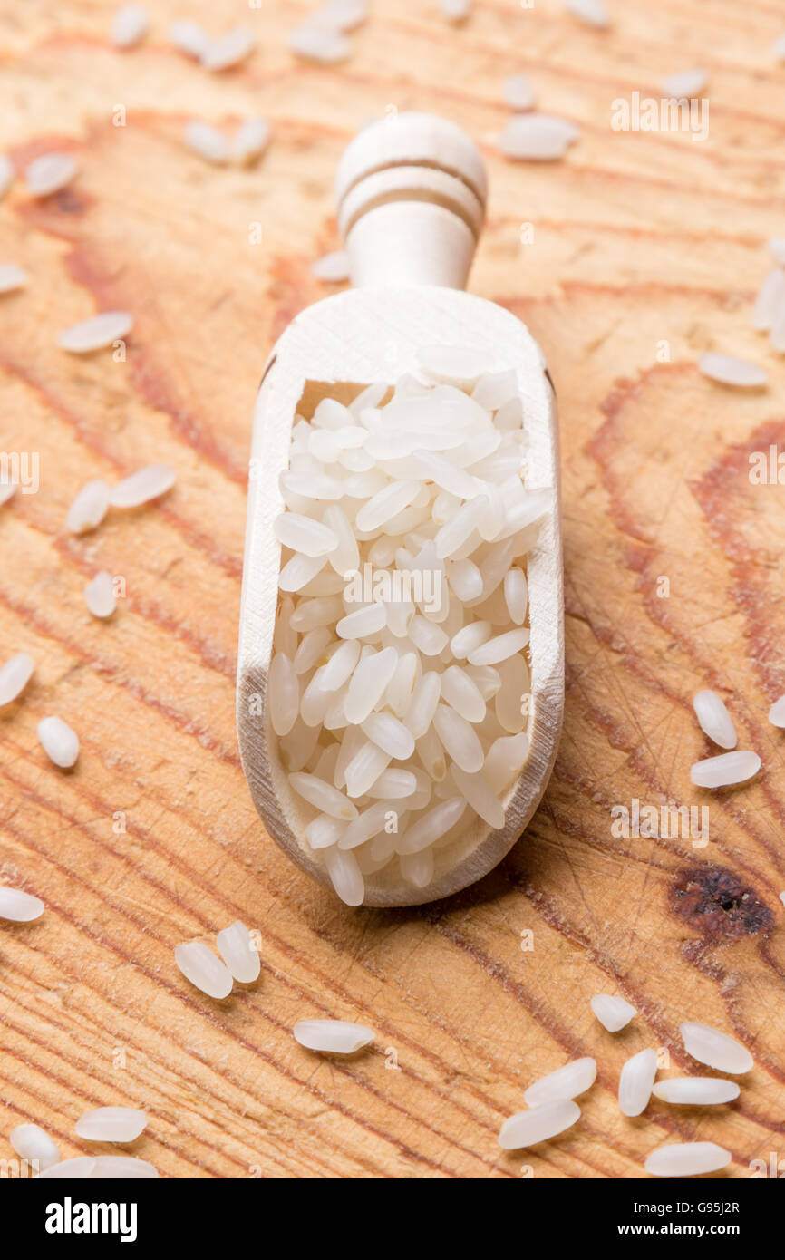 white rice on table with wooden scoop Stock Photo - Alamy