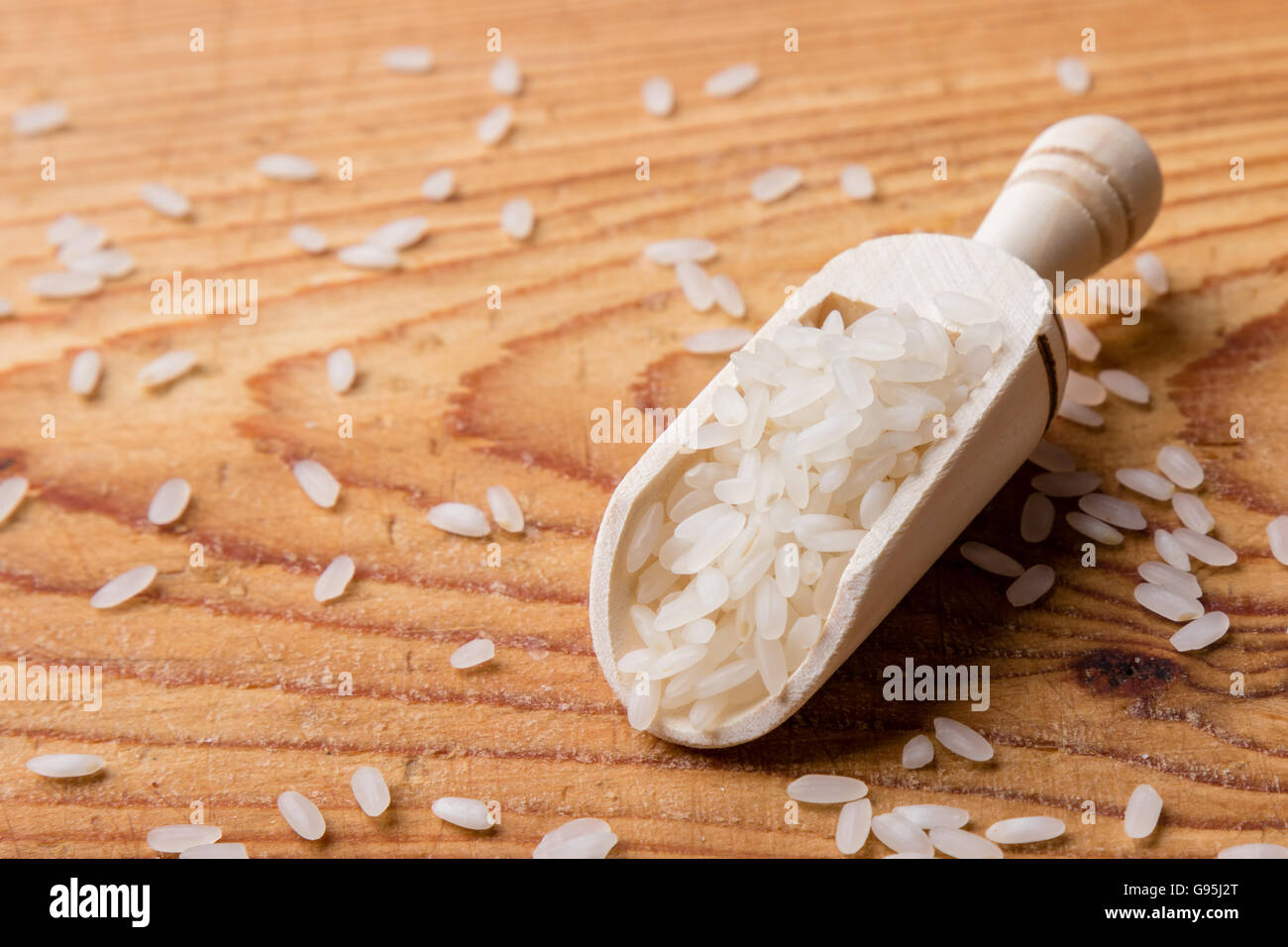 white rice on table with wooden scoop Stock Photo - Alamy