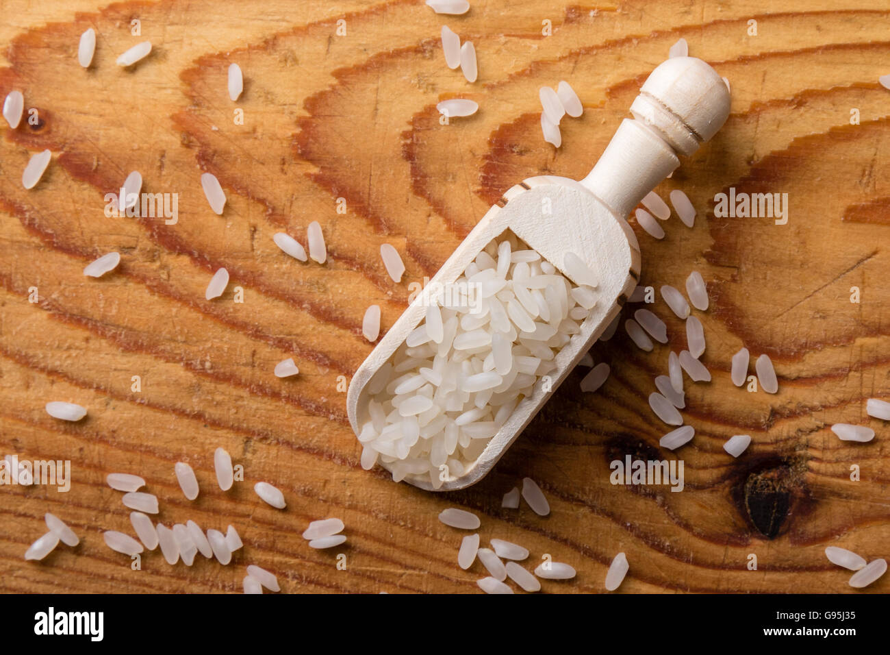 white rice on table with wooden scoop Stock Photo - Alamy
