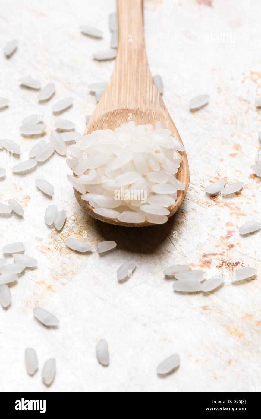 rice on wooden spoon on steel plate Stock Photo - Alamy