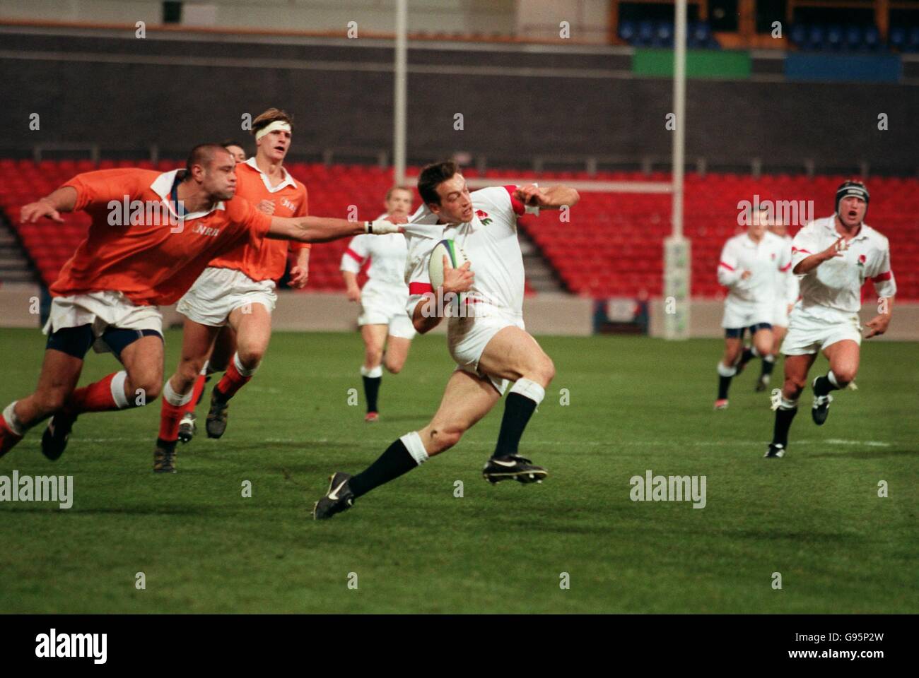 Englands dan luger is pulled back during run towards goal hi-res stock ...