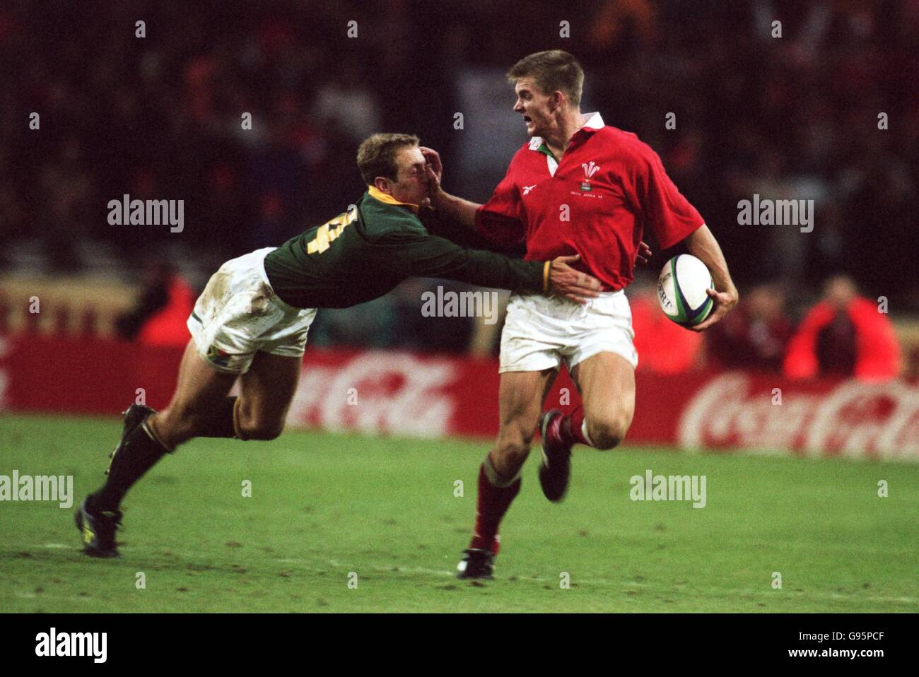 l-r South Africa's Stefan Terblanche is handed off by Wales' Dafydd ...