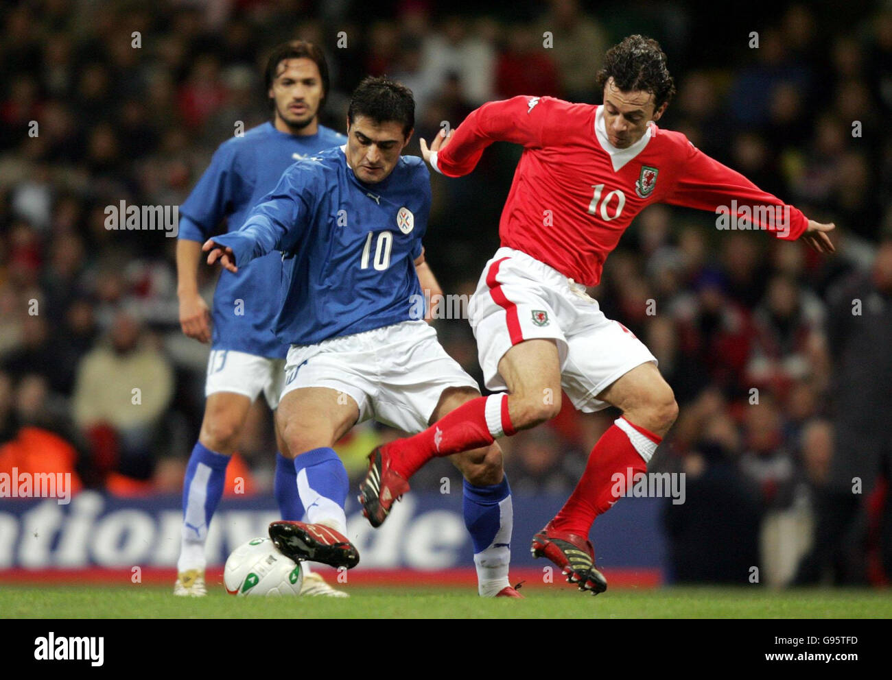 Wales' Simon Davies (R) challenges Paraguay's Roberto Acuna during the ...