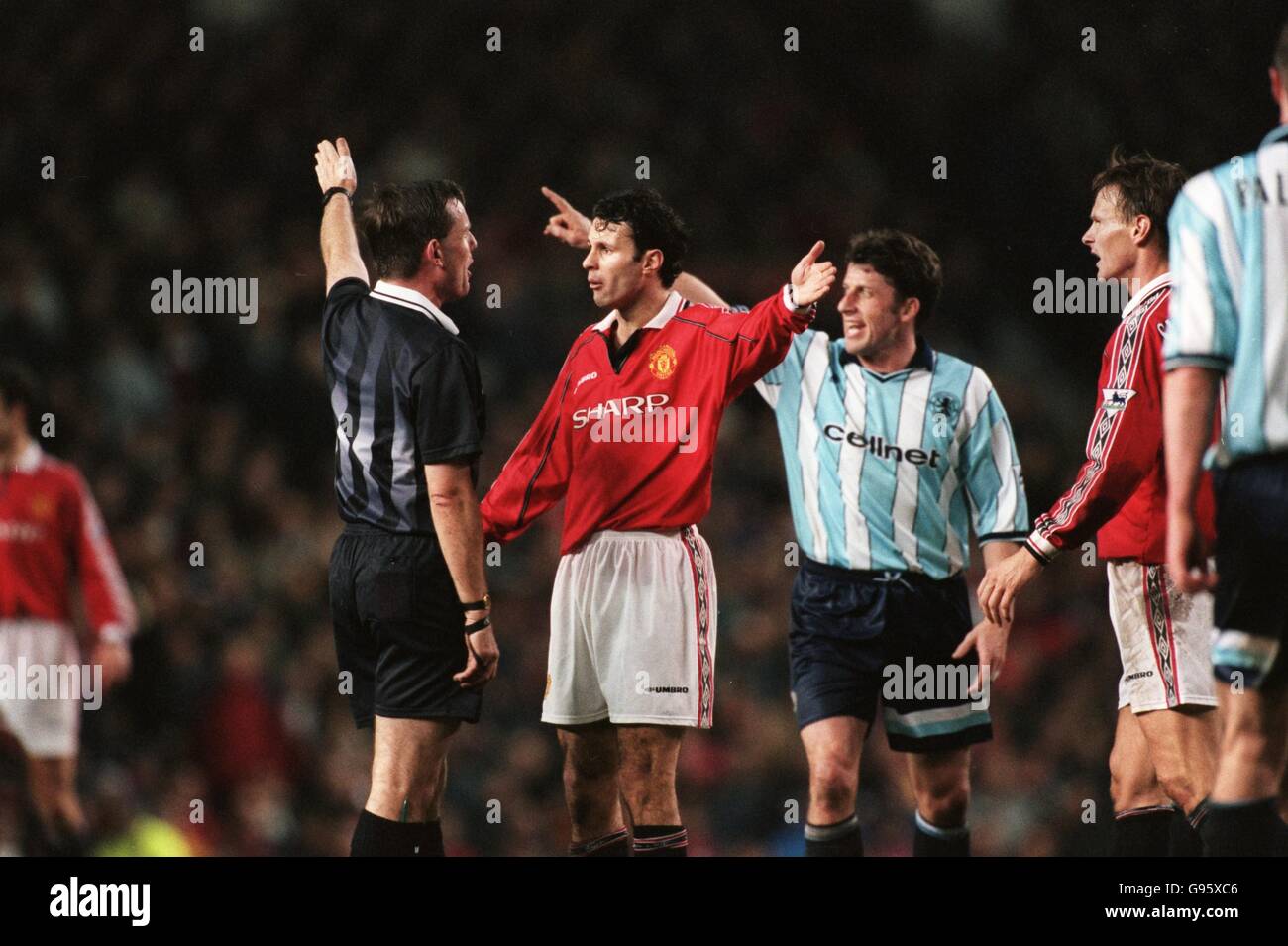 Ryan Giggs of Manchester United (centre) disagrees with referee Gary ...