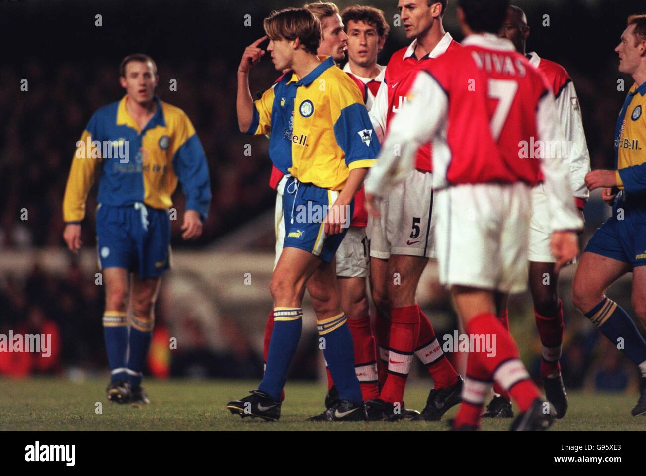 Leeds' Alan Smith points to his head after being head butted by Arsenal ...