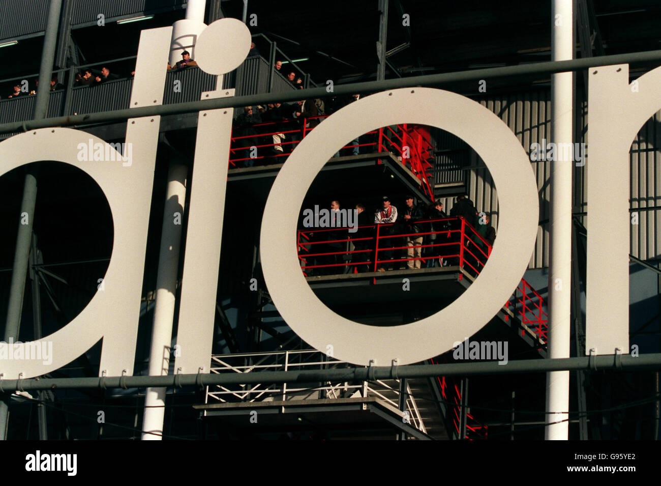 Fans look out from behind the huge sign for the De Kuip Stadium, home ...