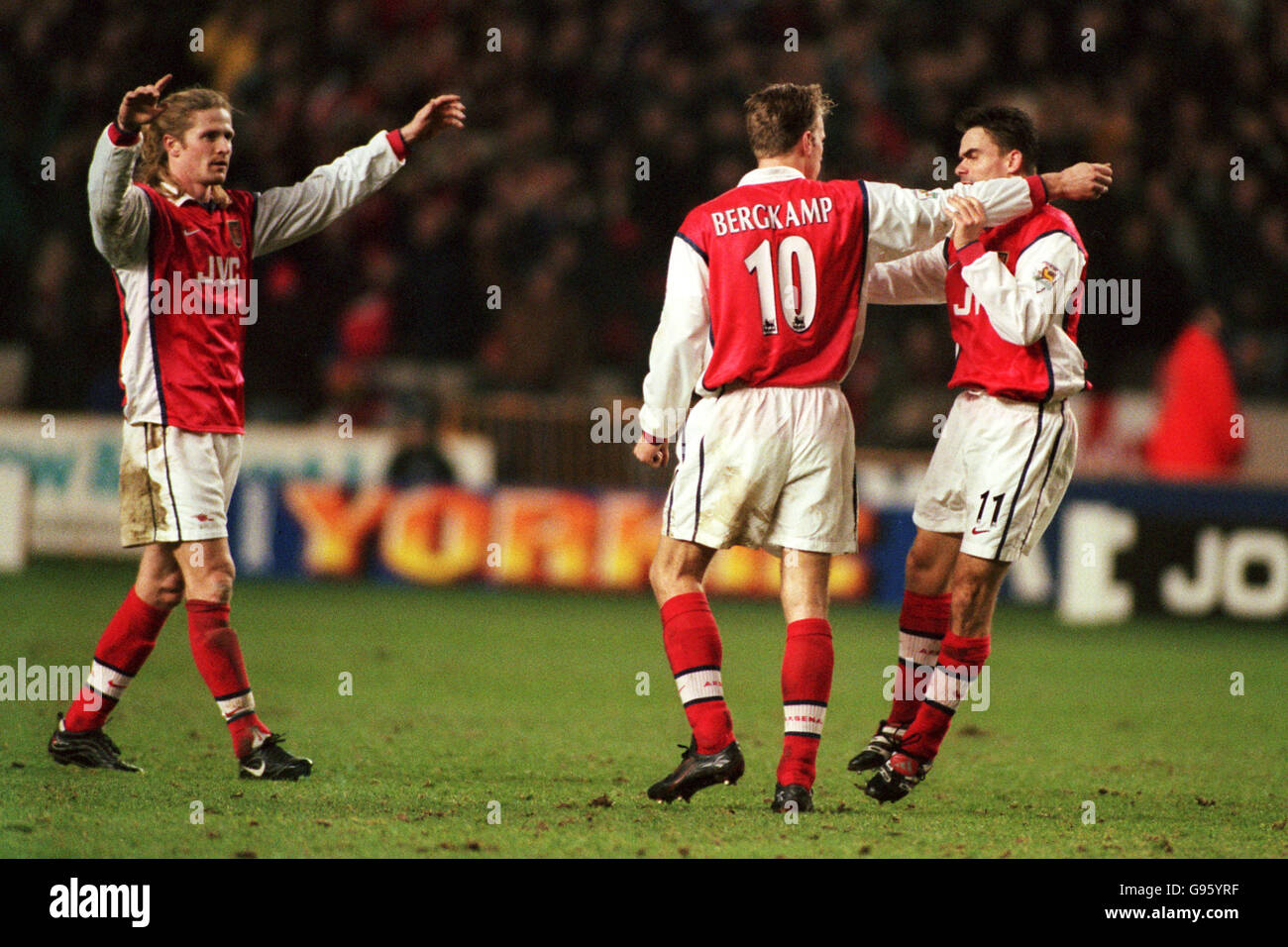 Arsenals Dennis Bergkamp celebrates with Marc Overmars and Emmanuel ... Arsenals Dennis Bergkamp celebrates with Marc Overmars and Emmanuel ...