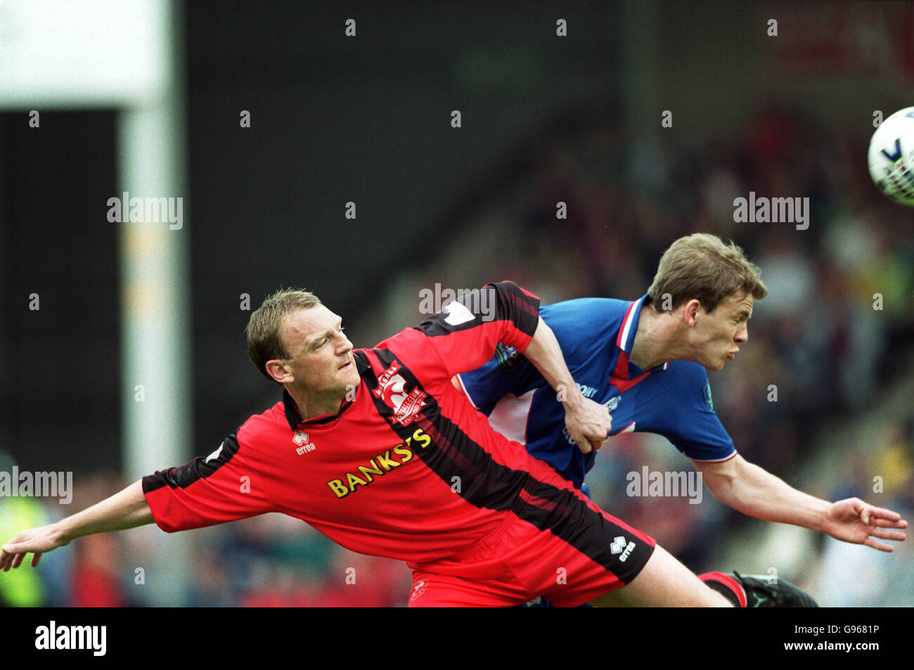 Walsall's Andy Rammell and Oldham Athletic's Stuart Thom battle for the ...