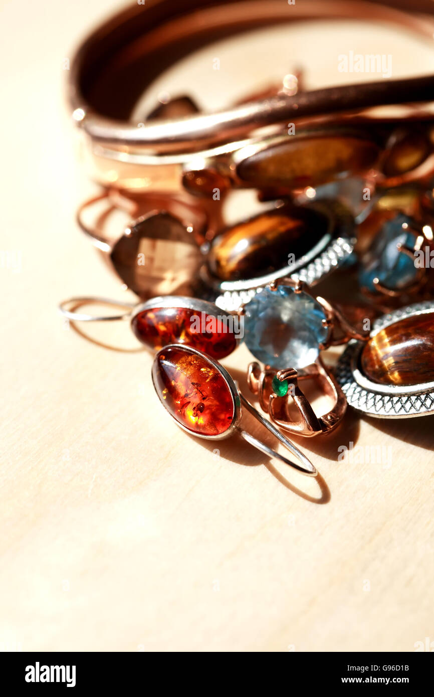 Set of various jewelry on wooden background under sunlight Stock Photo ...