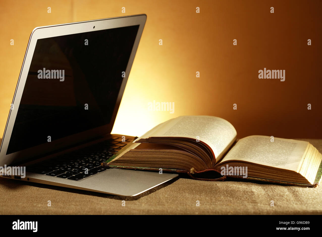 Education concept. Open laptop with blank screen near old book Stock ...