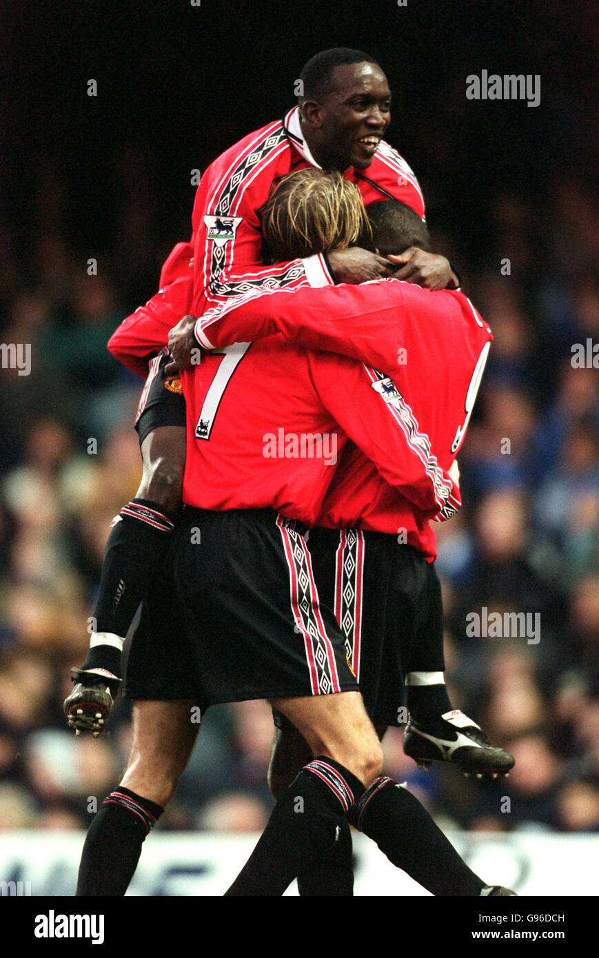 Manchester United's Dwight Yorke joins in the celebrations with David ...