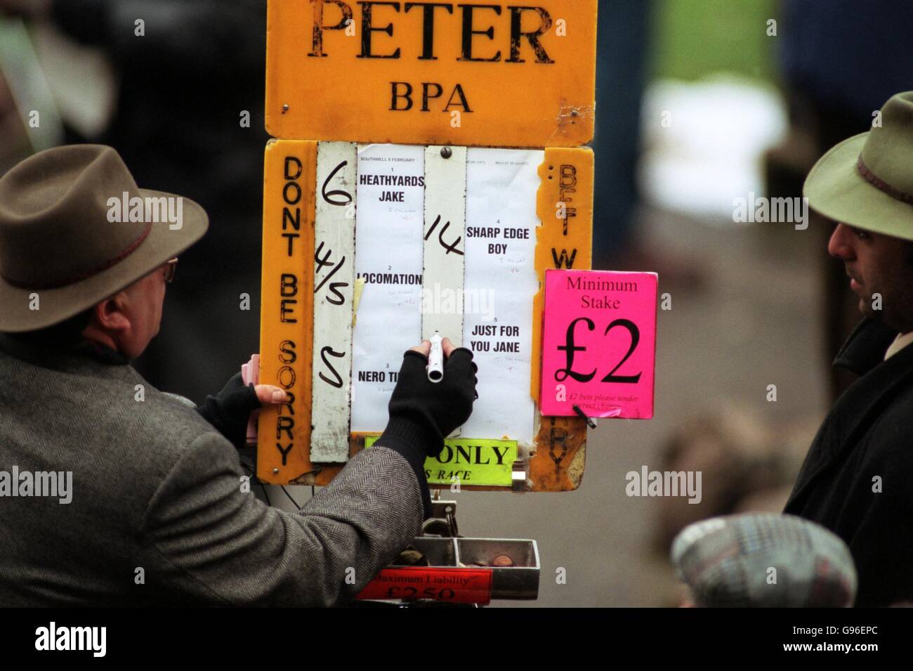 Horse Racing, Southwell Races. A bookmaker marks up the latest prices ...