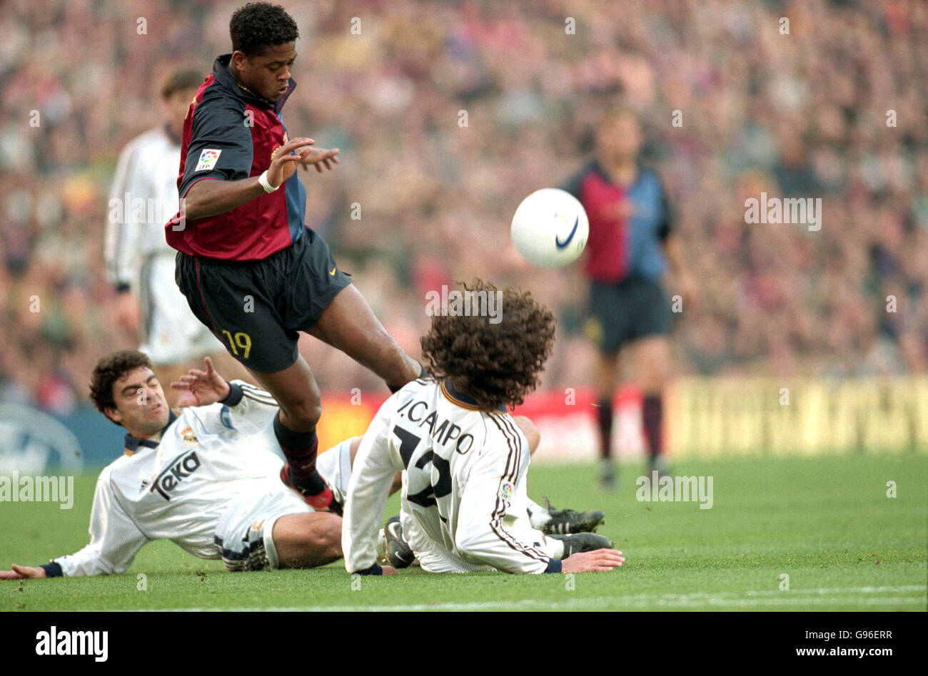 Barcelona's Patrick Kluivert is squashed by Real Madrid's Sanchis (left ...