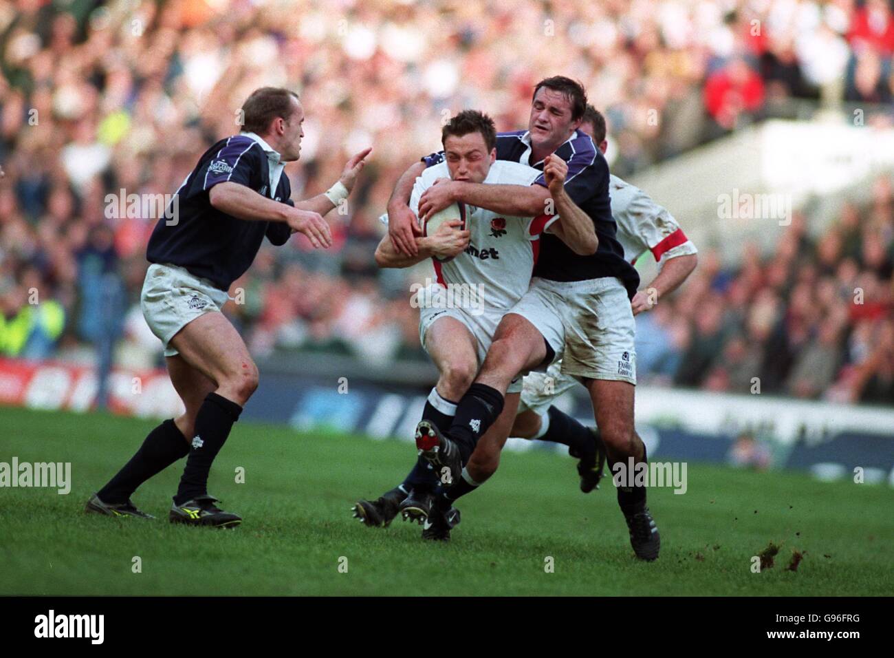 England's Dan Luger (centre) tries to surge between Scotland's Gregor ...