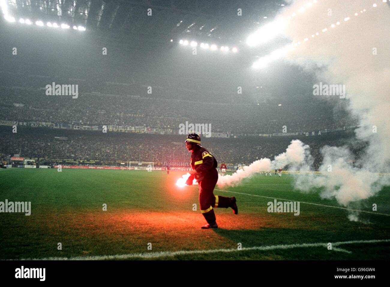 A fireman removes a flare from the pitch hi-res stock photography and ...