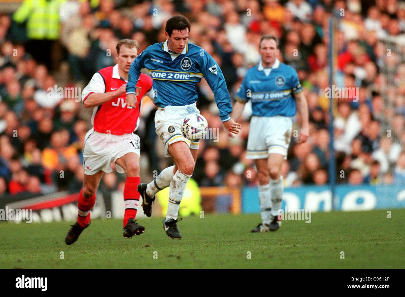 Everton's David Weir (right) bursts clear from Arsenal's Dennis ...