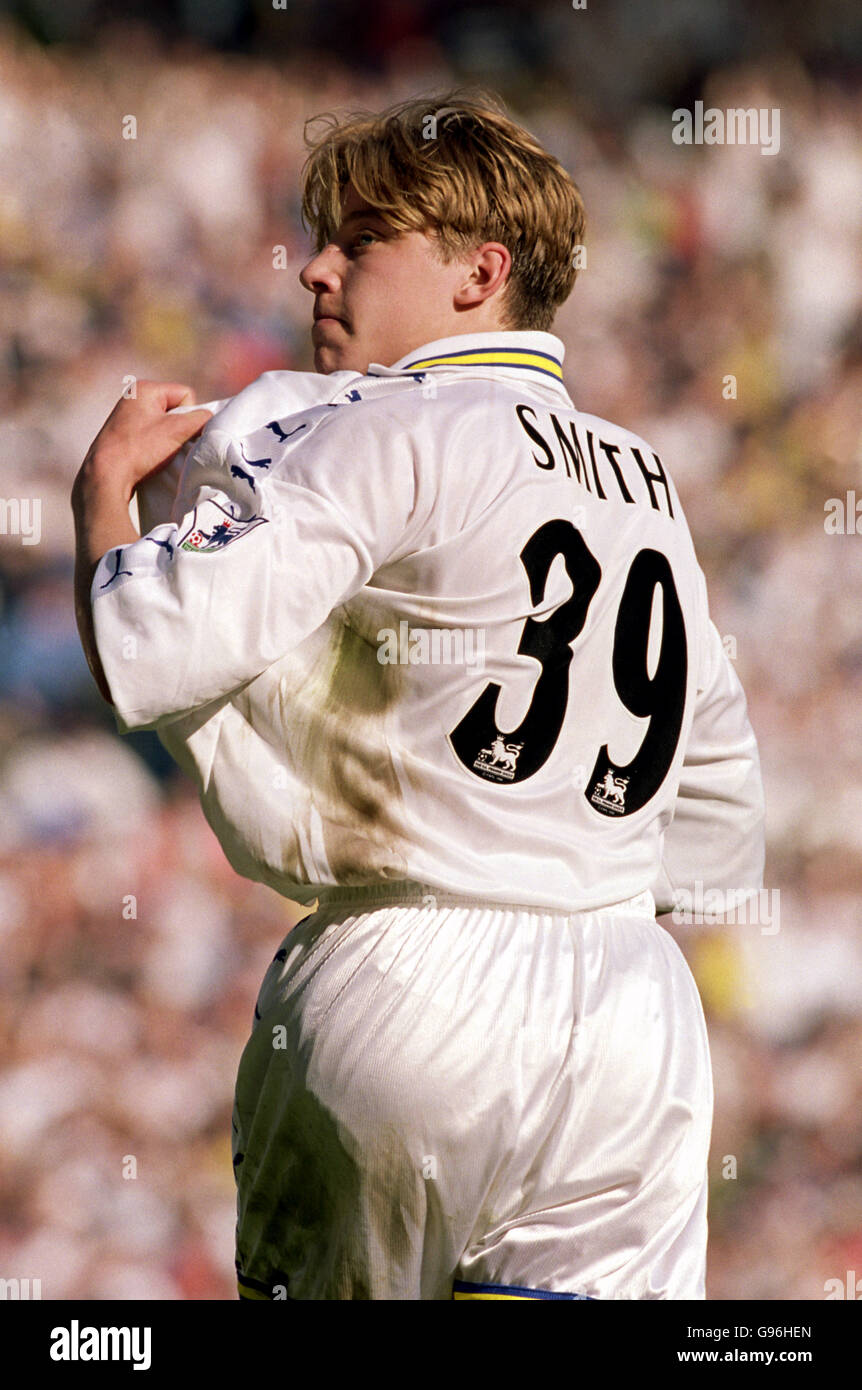 Leeds United's Alan Smith holds the team badge upto the home fans after ...