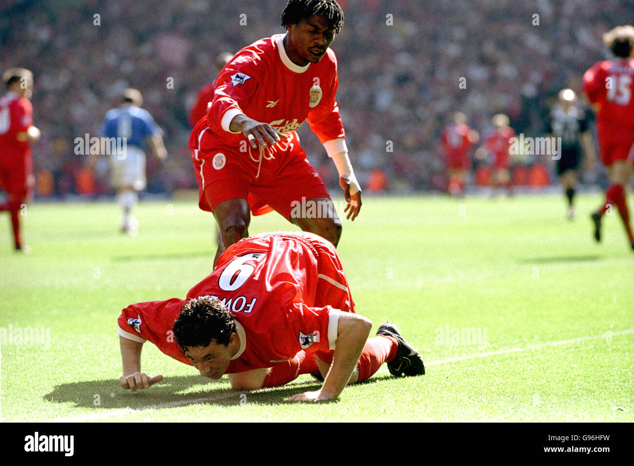Liverpool's Rigobert Song (standing) congratulates Robbie Fowler after ...