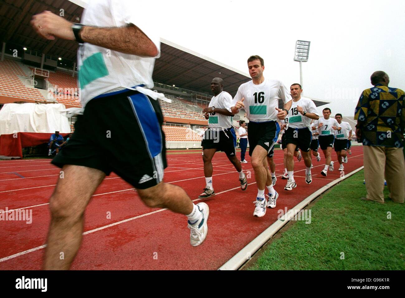 Referees undergoing their fitness tests jog round the track Stock Photo ...