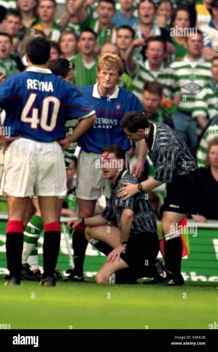Colin Hendry of Rangers stands over injured referee Hugh Dallas, as ...