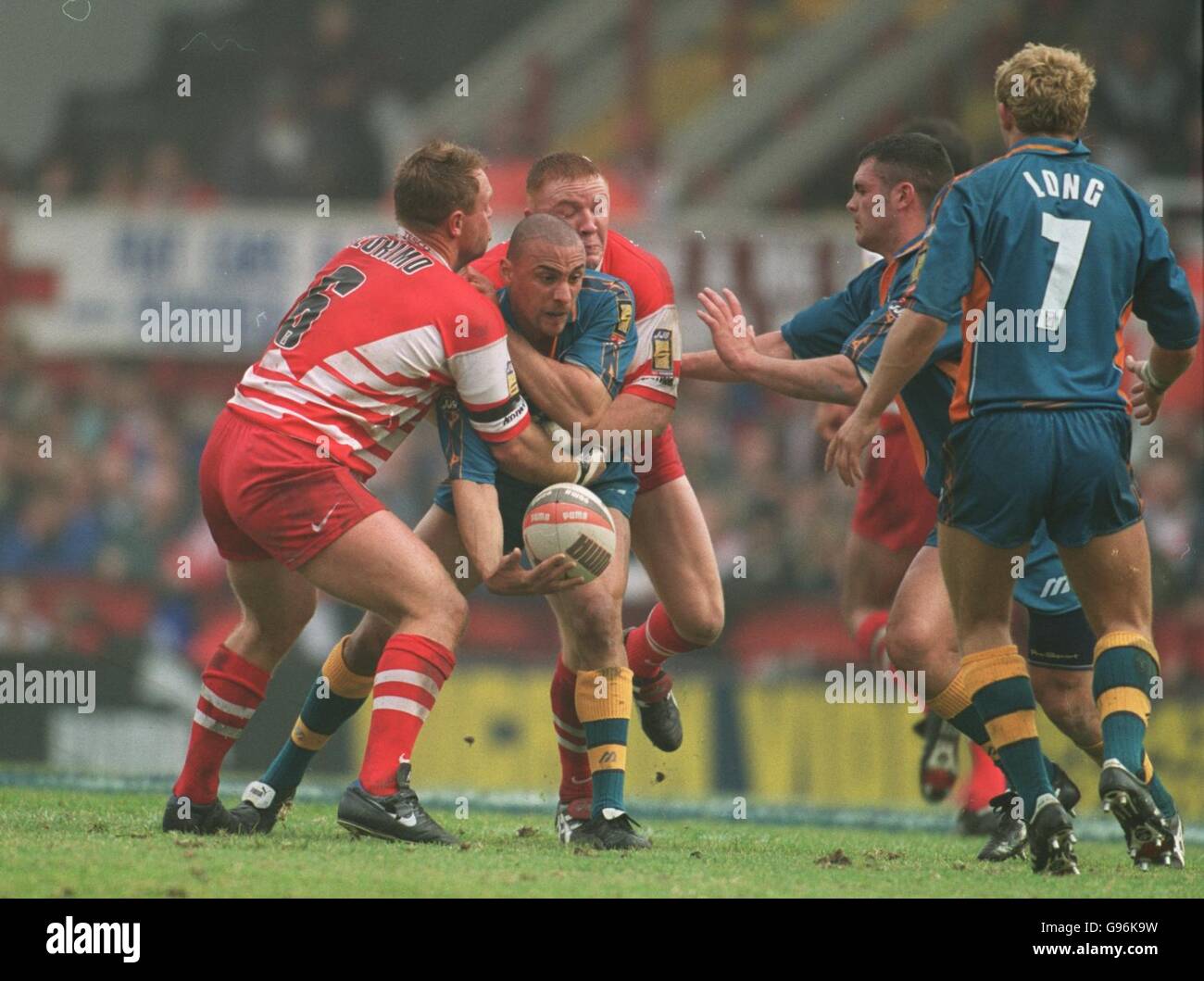 Anthony Sullivan of St Helens Saints (centre) looks to pass the ball as ...